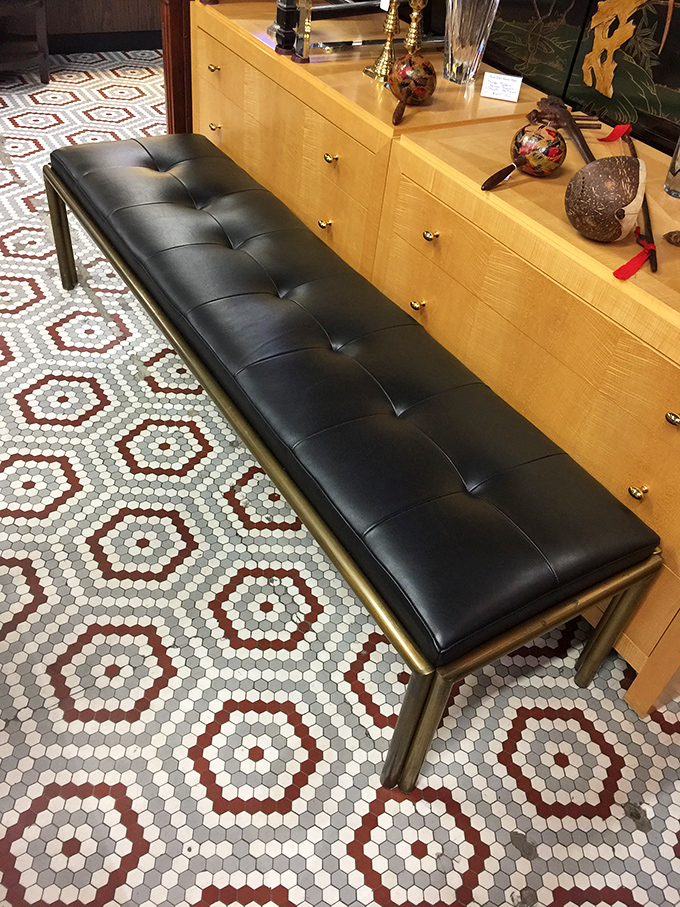 This tufted leather bench with brass frame isn't just seating&mdash;it's a statement piece that whispers "I have excellent taste" to your guests.