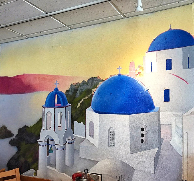 A Greek-inspired mural adds unexpected charm, reminding you that the best diners always have a touch of personality on their walls.