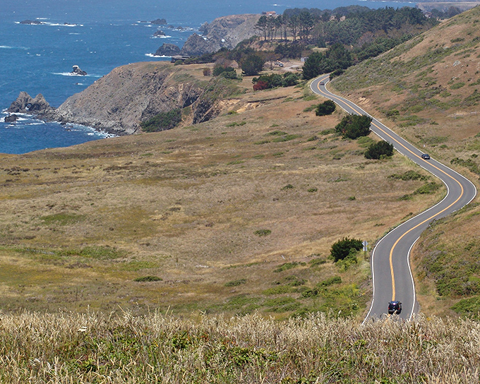 The road unfurls like a ribbon dropped from heaven, connecting earth and sky in California's most beautiful commute.