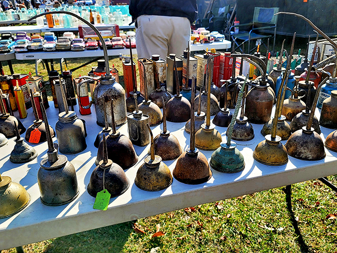 Vintage oil cans stand at attention like rusty soldiers, their weathered labels preserving bygone brands and gas station memories.