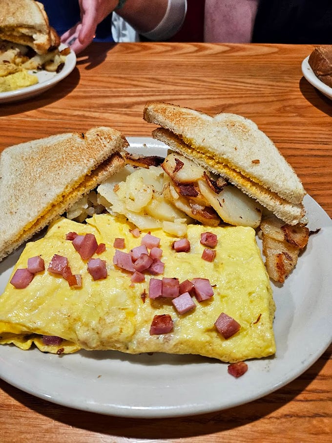This isn't just an omelet&mdash;it's a morning masterpiece. Fluffy eggs cradling ham and cheese, with perfectly golden home fries and toast standing by.