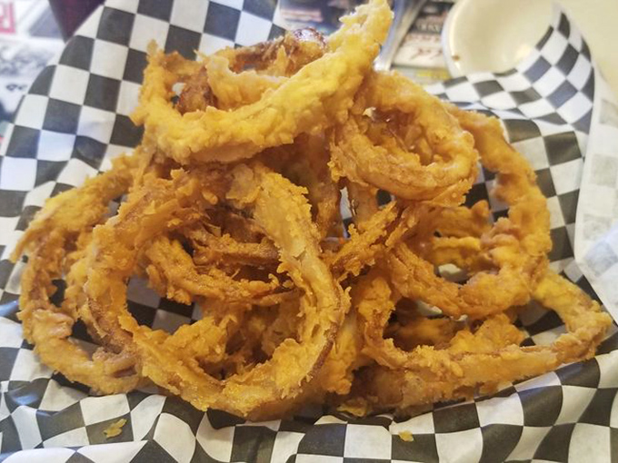 A mountain of crispy onion rings that could double as edible jewelry, if edible jewelry were absolutely delicious and gone immediately.