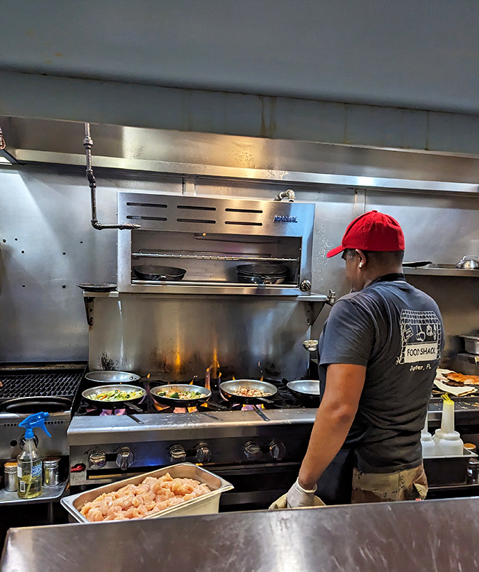 Where the magic happens. The open kitchen reveals the choreographed dance of flames and fresh ingredients that makes Food Shack legendary.
