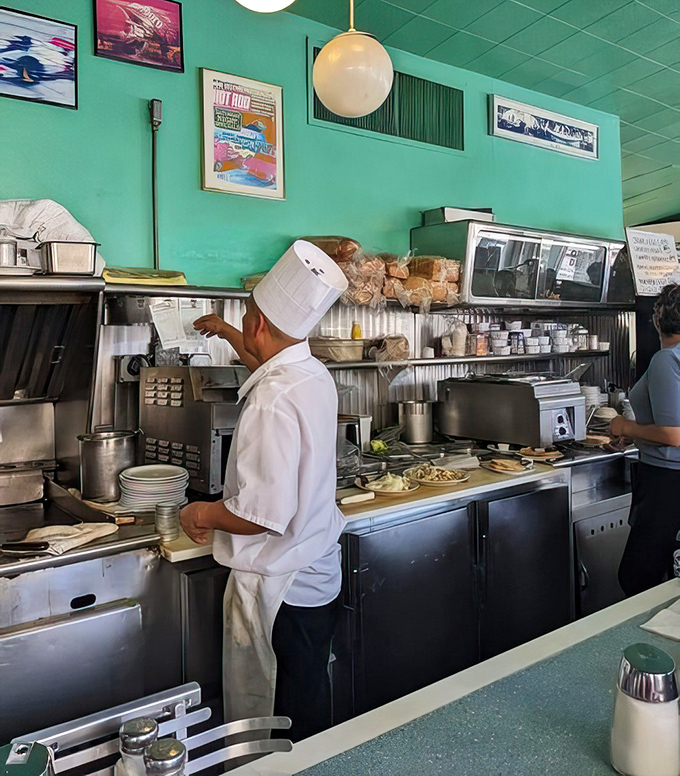 Chefs in traditional whites working with practiced efficiency. No tweezers or squeeze bottles in sight&mdash;just the beautiful choreography of short-order cooking.