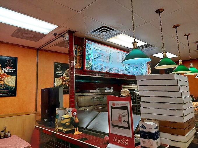 Behind every great pizza is a counter like this&mdash;organized chaos where magic happens under green lamps and beside stacked boxes awaiting their precious cargo.