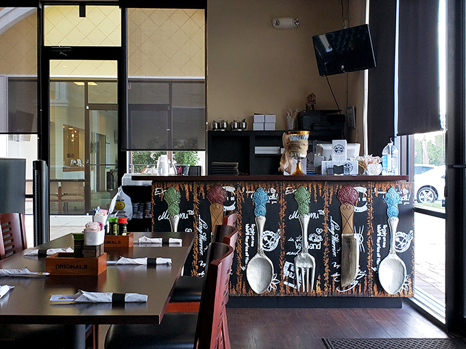 Even the order counter has personality, with playful utensil artwork that hints at the fun approach to serious cooking.