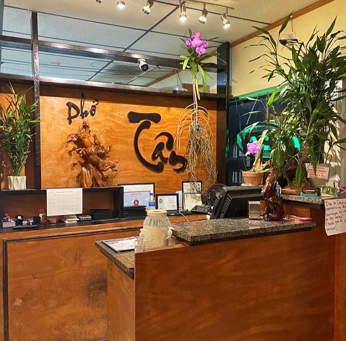 The wooden sign and orchids at the counter add a touch of elegance to this family-run spot where hospitality matters as much.