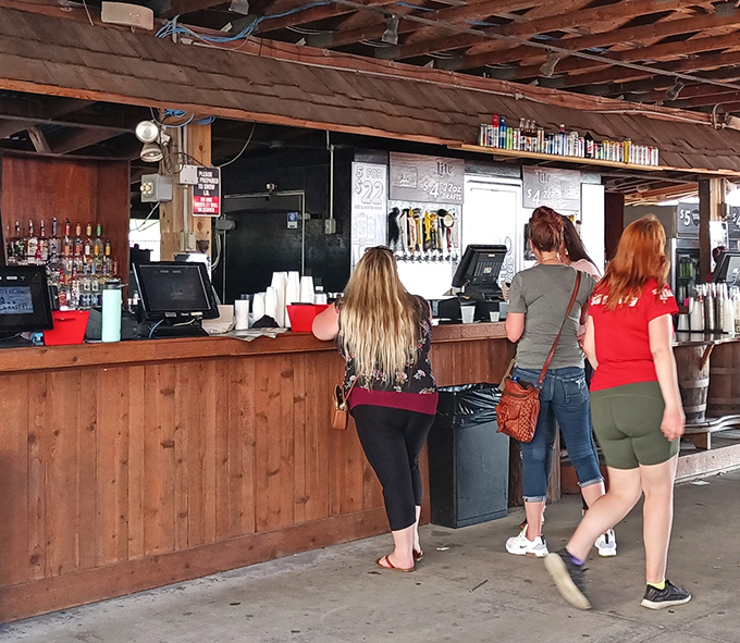 Where the magic begins. Friendly faces await behind this wooden counter, ready to fuel your lakeside adventure with cold drinks.