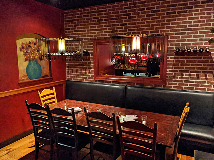 A dining nook that feels like it was designed for both intimate conversations and comfortable solitude, with exposed brick that whispers "stay awhile."