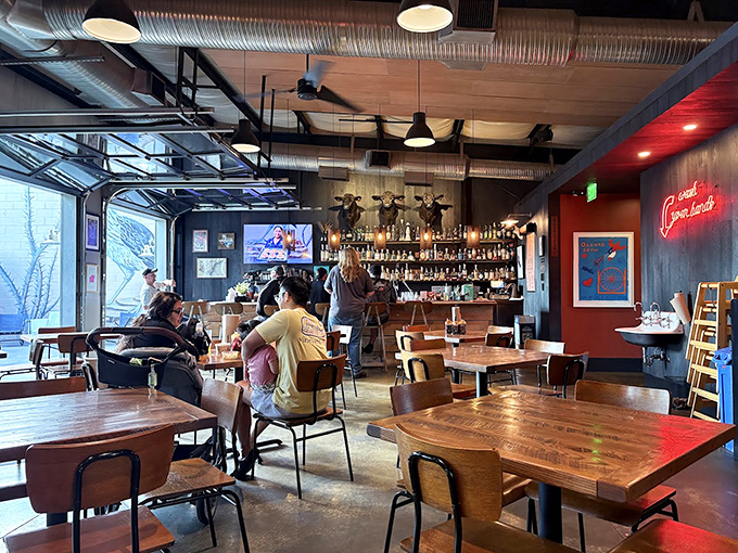 The dining room balances rustic charm with urban cool. It's the kind of space where strangers become friends over shared barbecue enthusiasm.