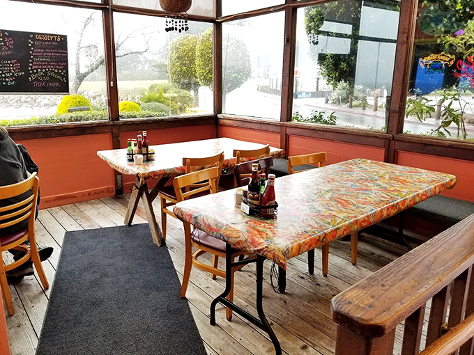 The sunroom dining area offers a greenhouse effect without the humidity&mdash;natural light illuminating those colorful tablecloths while you feast.