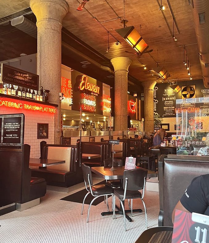 Vintage charm meets modern comfort in this dining room where stone columns and neon signs create the perfect backdrop for serious eating.