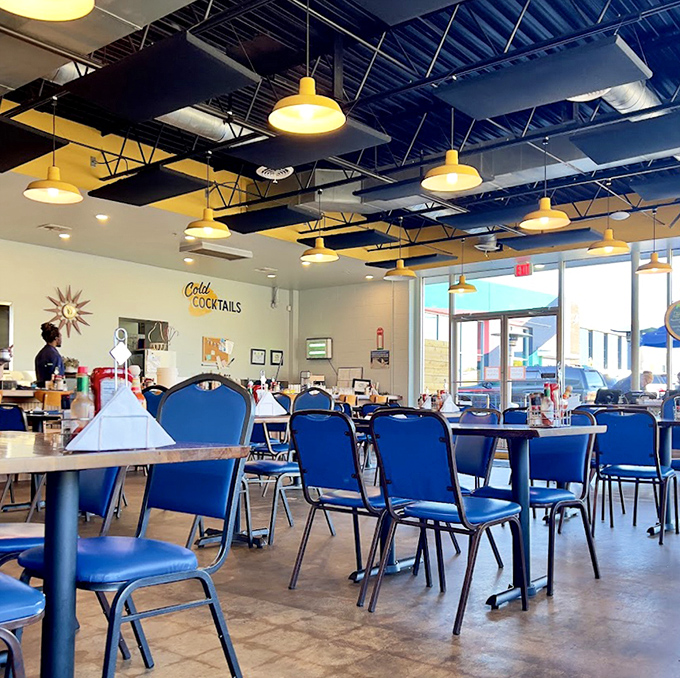 Bright lights, blue chairs, and enough space to accommodate both your breakfast dreams and your weekend sweatpants&mdash;diner design at its most inviting.