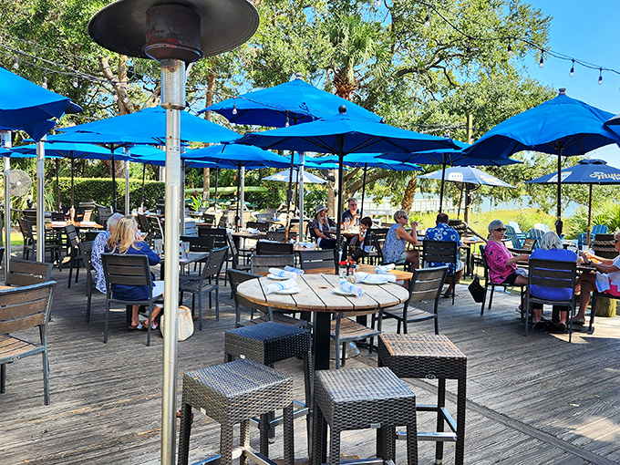 The outdoor deck offers front-row seats to nature's dinner theater&mdash;blue umbrellas, gentle breezes, and occasional dolphin cameos included.