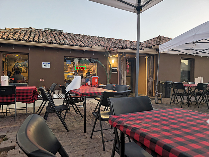 Red and black checkered tablecloths add a touch of casual charm to the outdoor seating area&mdash;Arizona dining at its most authentic.