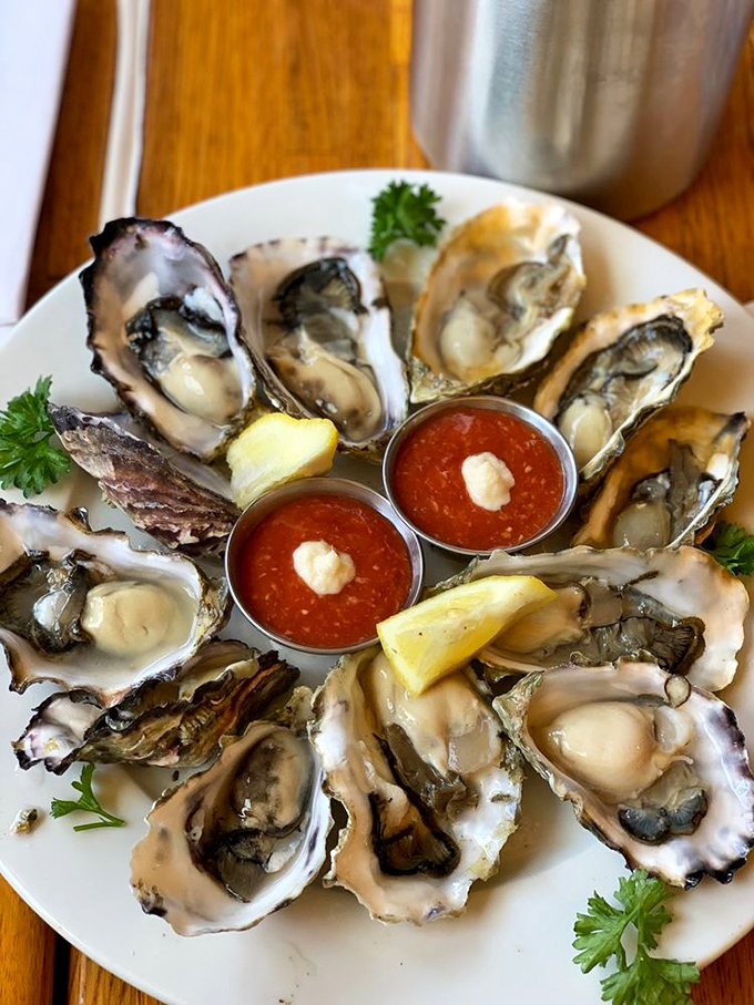 These oysters aren't just served—they're presented like jewelry, with cocktail sauce gems and lemon wedge accents.