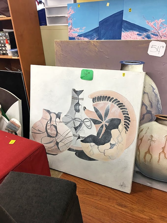 Abstract art meets mid-century design in this collection of paintings. That green price tag means someone's living room is about to get classier.