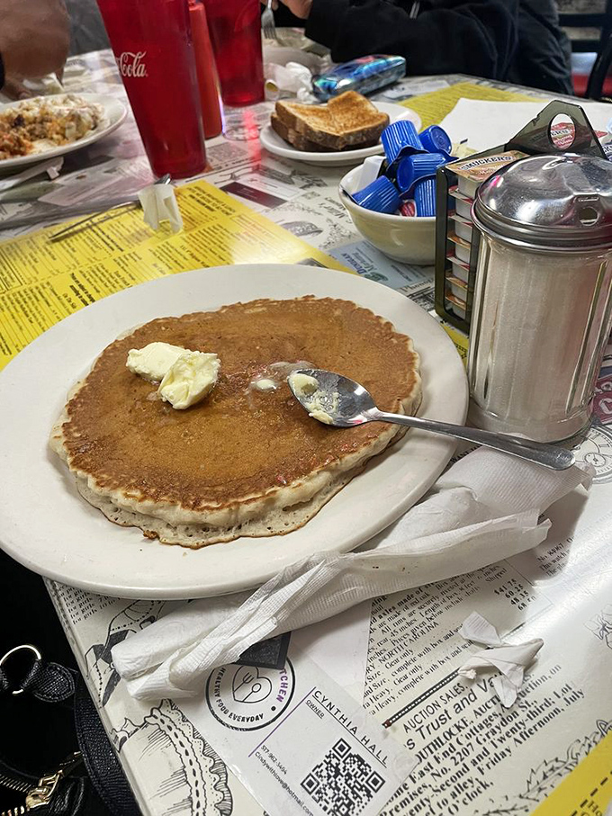 A pancake so perfectly golden it could win medals. That pat of butter is just beginning its delicious journey of melty goodness.
