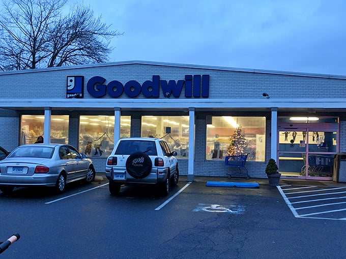As evening approaches, the Goodwill's warm glow promises last-minute treasures for shoppers squeezing in a quick visit before closing time.