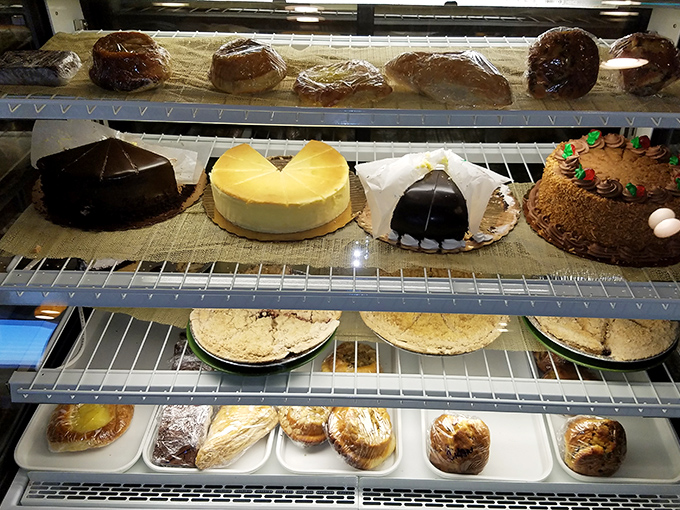 The dessert case&mdash;where willpower goes to die a glorious death. Those cakes aren't just desserts; they're architectural achievements with buttercream foundations.