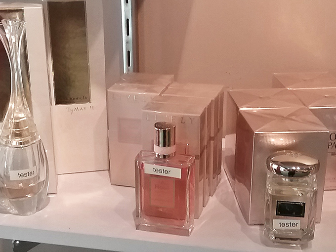 Perfume testers lined up like sophisticated soldiers. One spritz and you'll smell like you paid full price at a fancy department store.