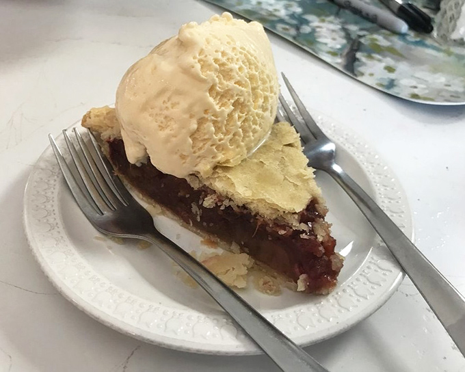 Pie served on a simple white plate with ice cream, because even legends don't need to show off with fancy presentations.