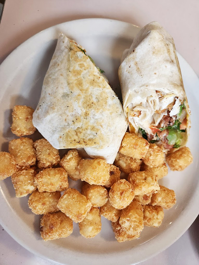 Wrap royalty with a side of golden tots. This handheld masterpiece proves Frank's excels beyond breakfast with fresh ingredients and perfect execution.
