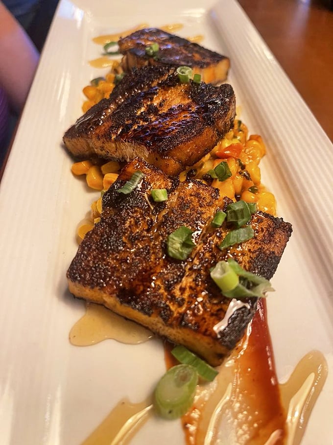 Pork belly that glistens with promise atop sweet corn. Each piece is a perfect trilogy of crispy exterior, melting fat, and tender meat&mdash;the holy trinity of pork perfection.