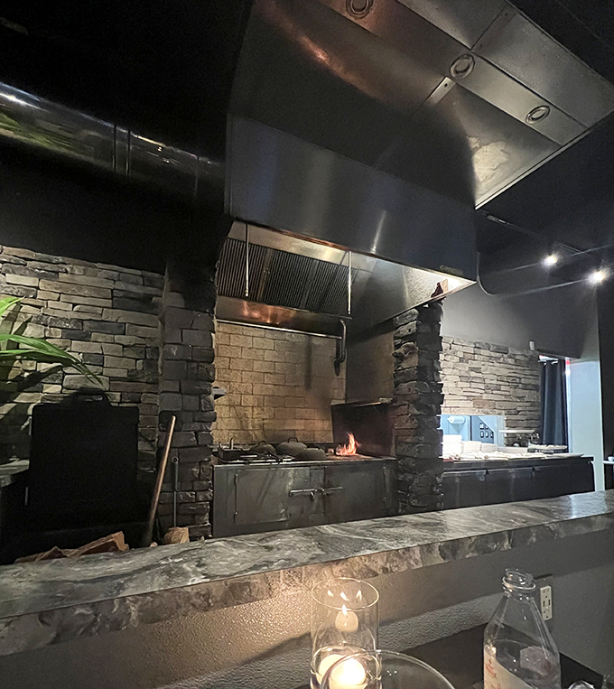 The heart of the operation&mdash;a magnificent wood-fired grill surrounded by stone, where beef transforms from excellent to extraordinary through flame and skill.