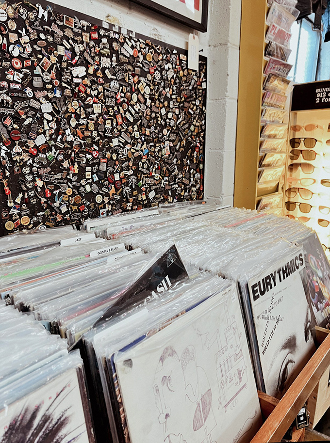 Vinyl collectors' paradise with a wall of pins documenting music history. Dig through these crates to find the soundtrack of your youth.