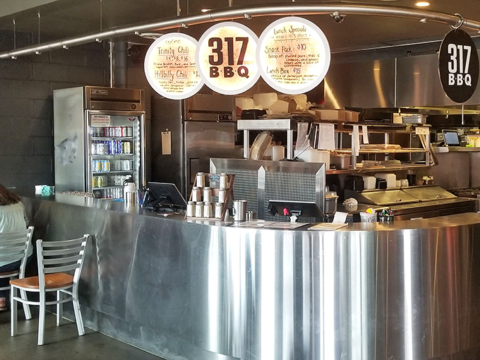 Behind this stainless steel counter, smoke magicians transform humble cuts into transcendent barbecue experiences worth crossing state lines for.