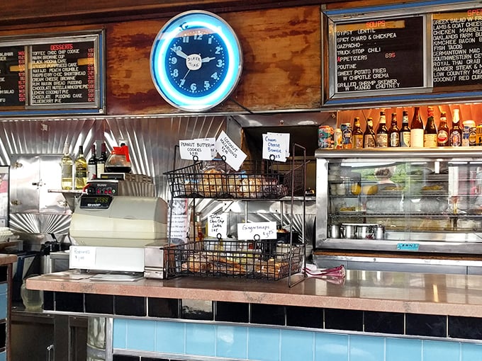 The neon clock glows above wire baskets of local goodies, reminding you that at A1, it's always time for something delicious.