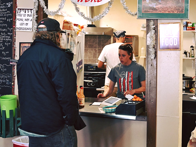 The pass-through window where breakfast dreams come true. That sign reminds us this is a menu, not a list of ingredients&mdash;because some things should remain deliciously mysterious.
