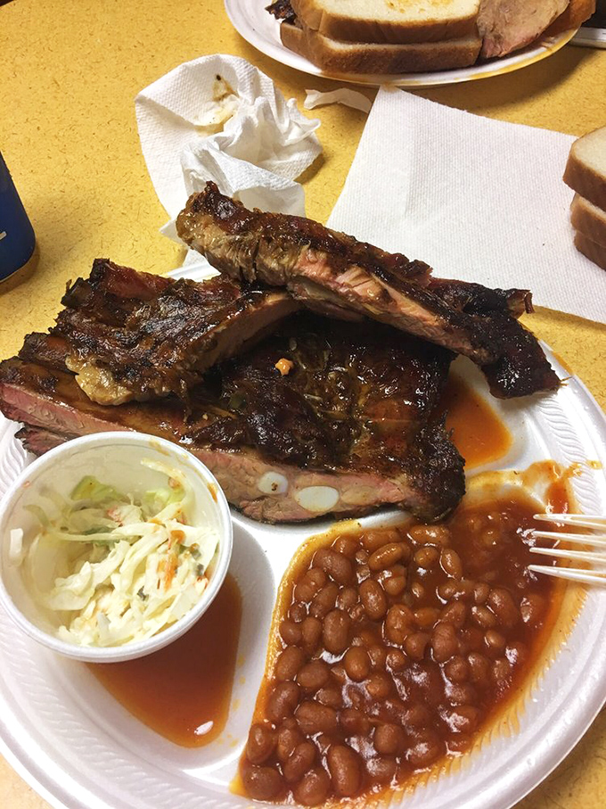 The full experience: ribs, slaw, beans, and bread. This isn't just lunch&mdash;it's a Southern ritual that demands respect and elastic waistbands.