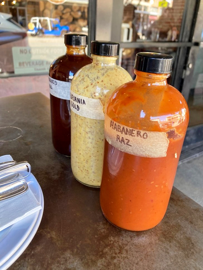 Three bottles of liquid magic, each promising to transform good barbecue into an out-of-body experience.