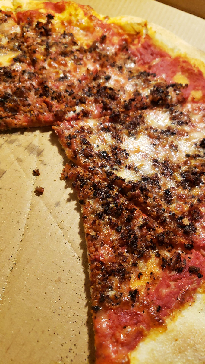 A close-up that reveals the perfect char marks on that sausage pizza. Those little black flecks are flavor crystals, my friends.