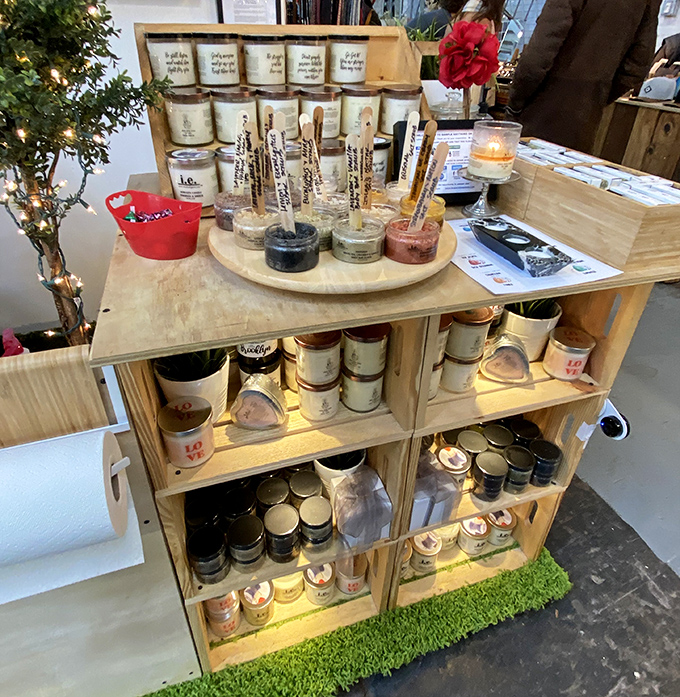 Artisanal candles arranged like a fragrance library, each promising to transport your nose to unexpected places.