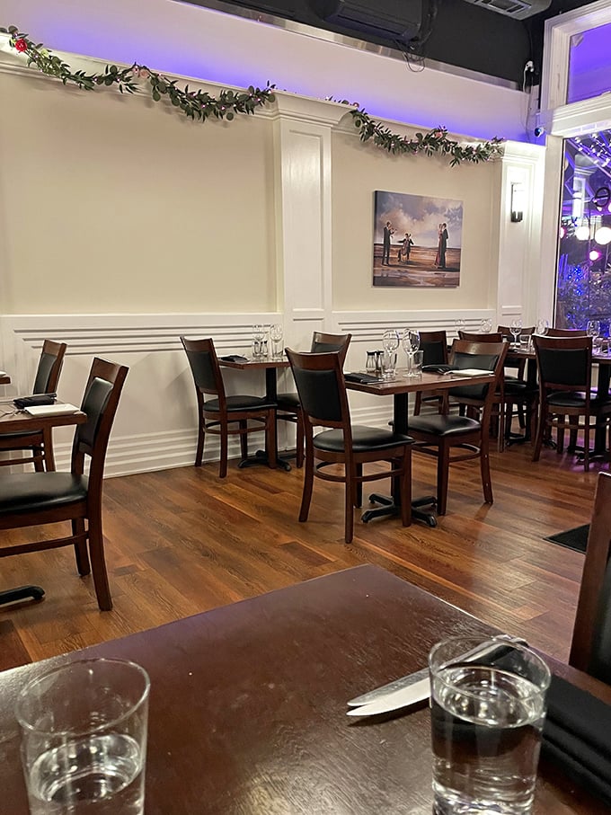 Simple elegance defines the dining space, where festive garlands add a touch of warmth to the sophisticated white walls and rich wood tables.