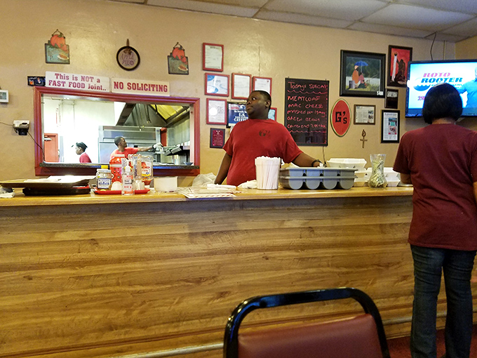 Behind the counter, where the magic happens. That sign isn't kidding &ndash; this is definitely NOT fast food, and that's precisely the point.