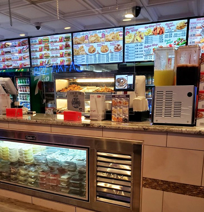 Digital menu boards showcase a universe of possibilities. Behind that counter, magic happens with flour, spices, and chicken that dreams of greatness.