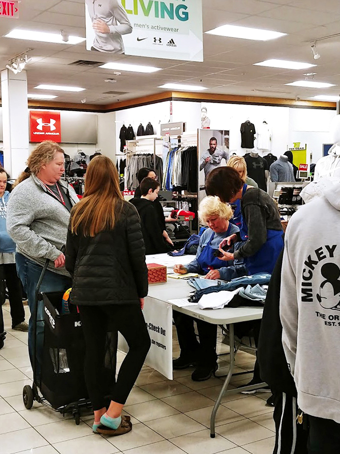 The checkout area buzzes with the energy of successful treasure hunters, where volunteers transform transactions into community connections.