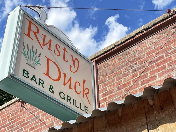 That mint-green sign against red brick has been guiding hungry folks to happiness for years now, one burger at a time.