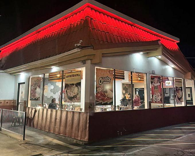 The snack bar glows with promise, its red-trimmed roof a beacon for hungry moviegoers seeking buttery popcorn and sugary treats.