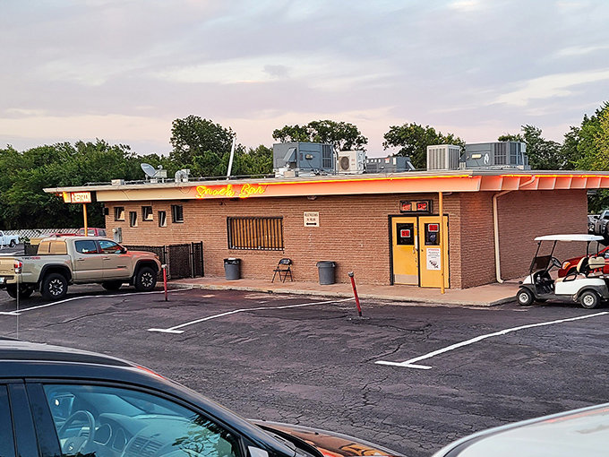 The snack bar—that hallowed temple of movie munchies where hot dogs rotate hypnotically and popcorn perfumes the air with buttery promises.