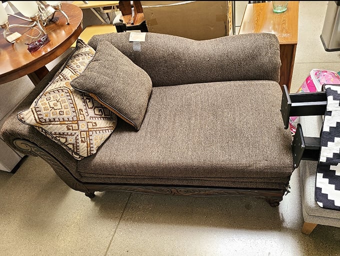 This vintage chaise lounge whispers tales of fancy parlors and afternoon naps, just waiting for its next chapter in someone's reading nook.