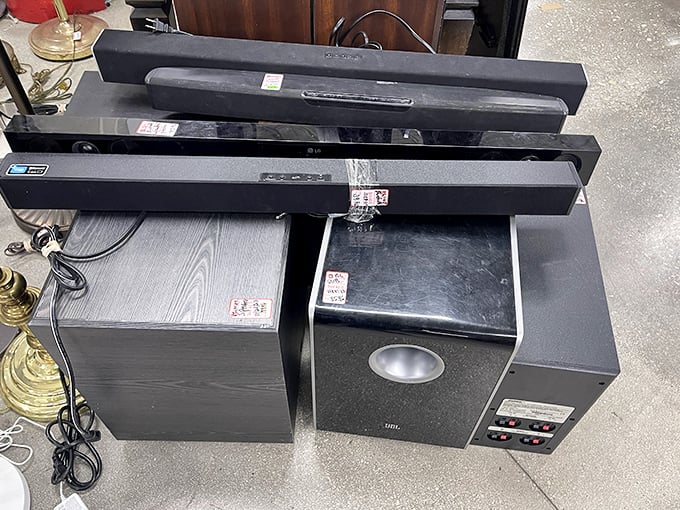 Home theater components stacked like urban audio architecture. Audiophiles on a budget can still achieve surround sound supremacy here.