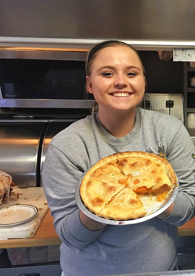 The smile of someone who knows exactly how good that pie tastes before you even order it.