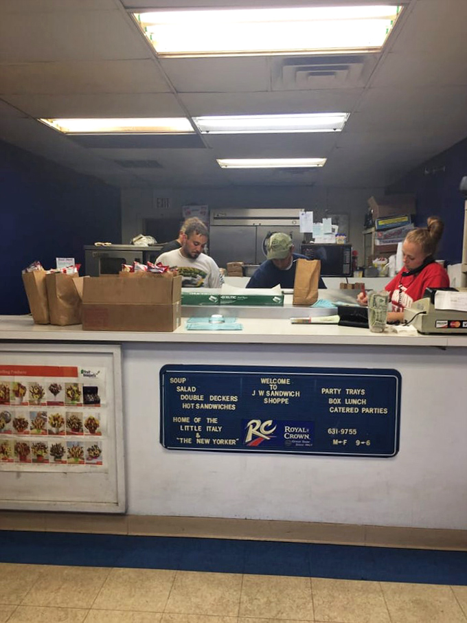 Behind the counter, sandwich artisans move with the synchronized precision of people who have made thousands of perfect lunches together.