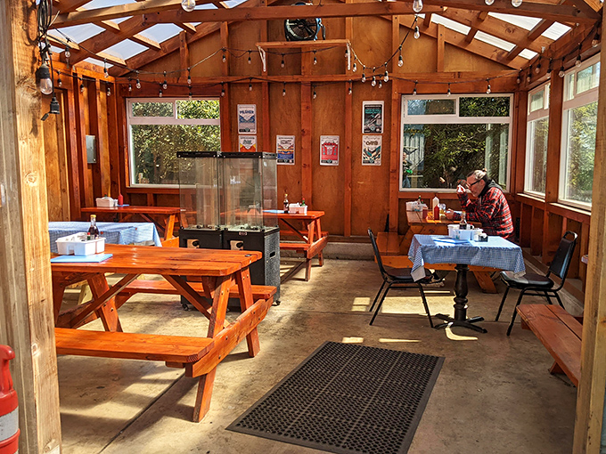 Sunshine streams through windows in the wooden dining area, where picnic tables invite strangers to become friends over shared seafood stories.