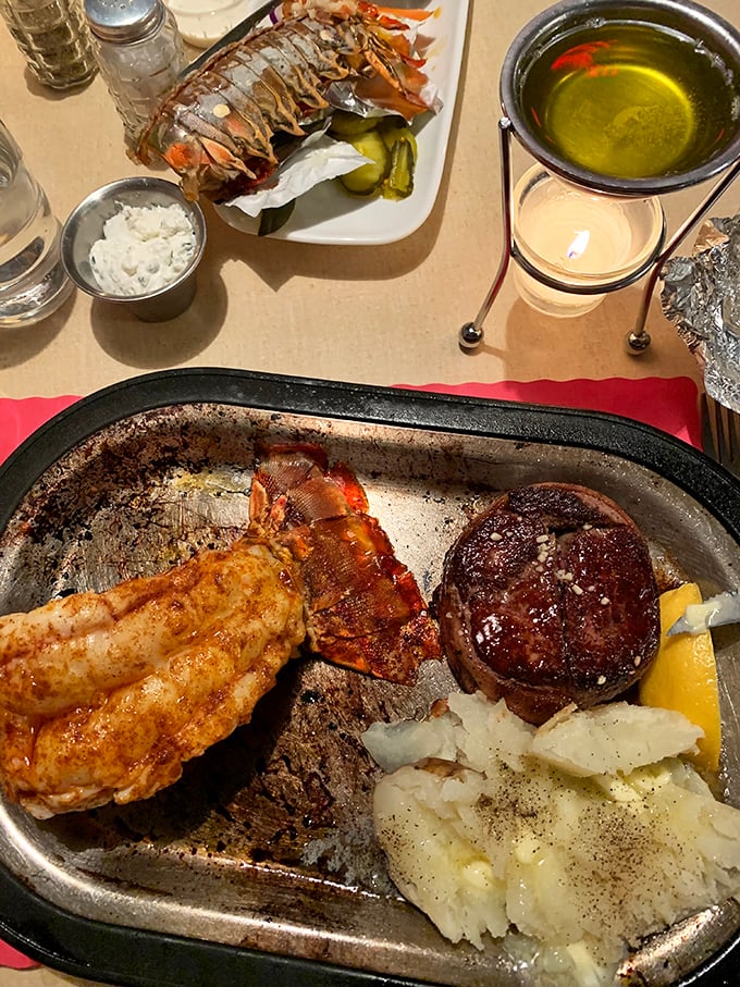 When land meets sea: lobster tail and steak create the ultimate alliance on a plate, with vegetables playing a supporting role.